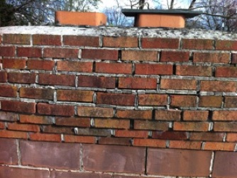 This chimney’s missing mortar joints need to be pointed.